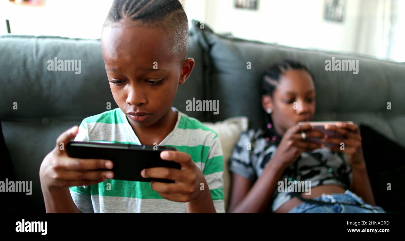 Children addicted to technology, kids watching screens at home absorbed ...