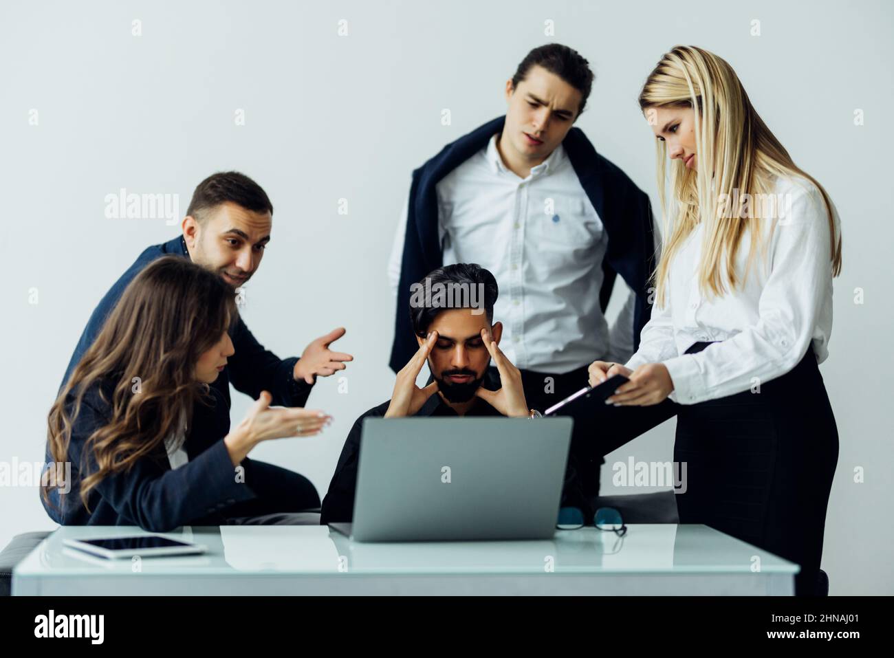 Business people gathered around laptop hi-res stock photography and ...