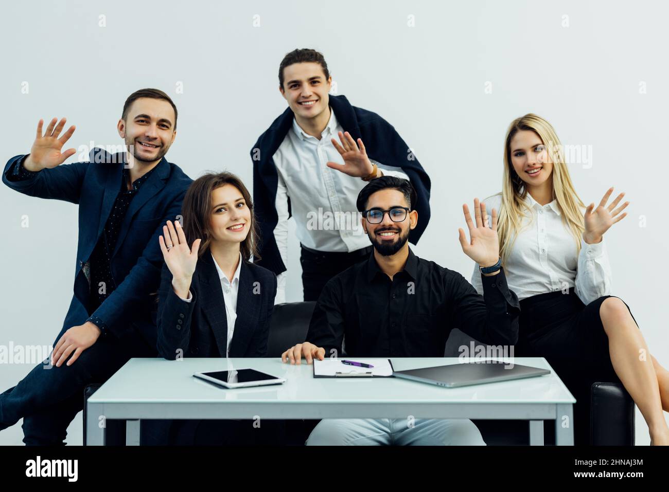 Company employees sitting at conference table in office having meeting ...