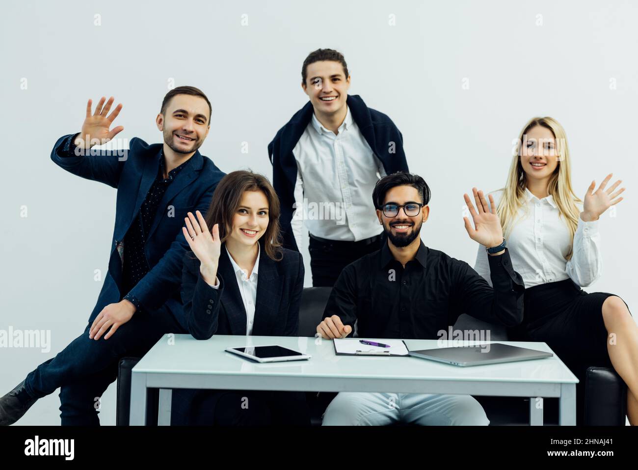 Company employees sitting at conference table in office having meeting ...