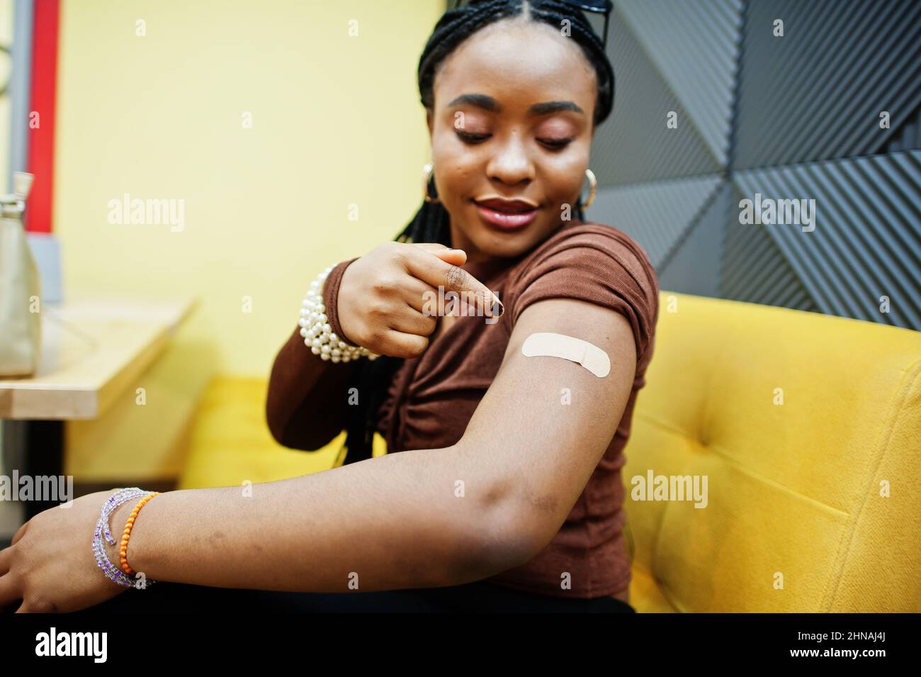 Stay safe! Black woman showing vaccinated arm after vaccine injection ...