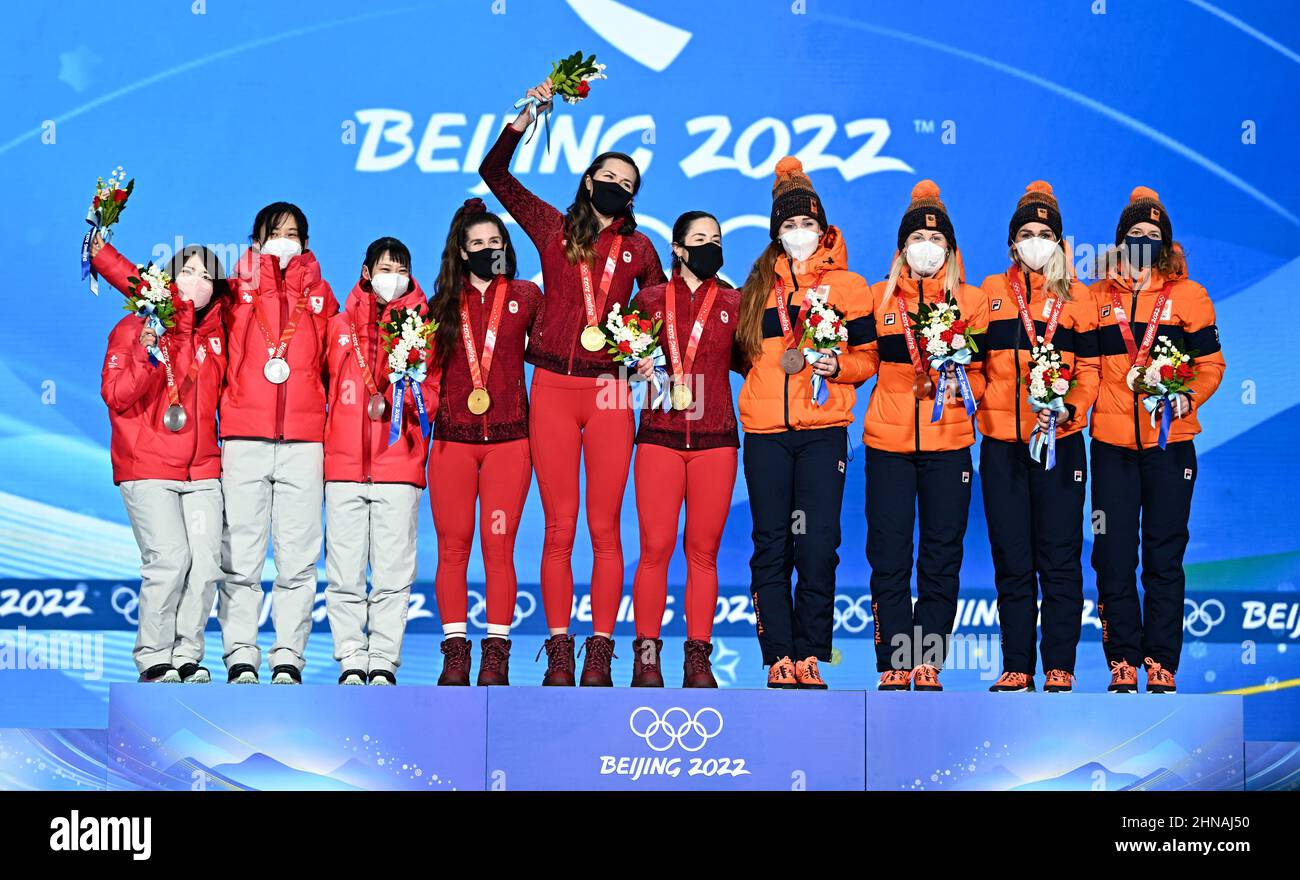 Beijing, China. 15th Feb, 2022. Gold medalists of Canada (C), silver medalists of Japan (L) and ...