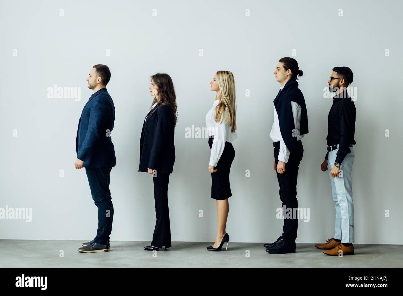 Long line of diverse professional business people standing in a queue ...