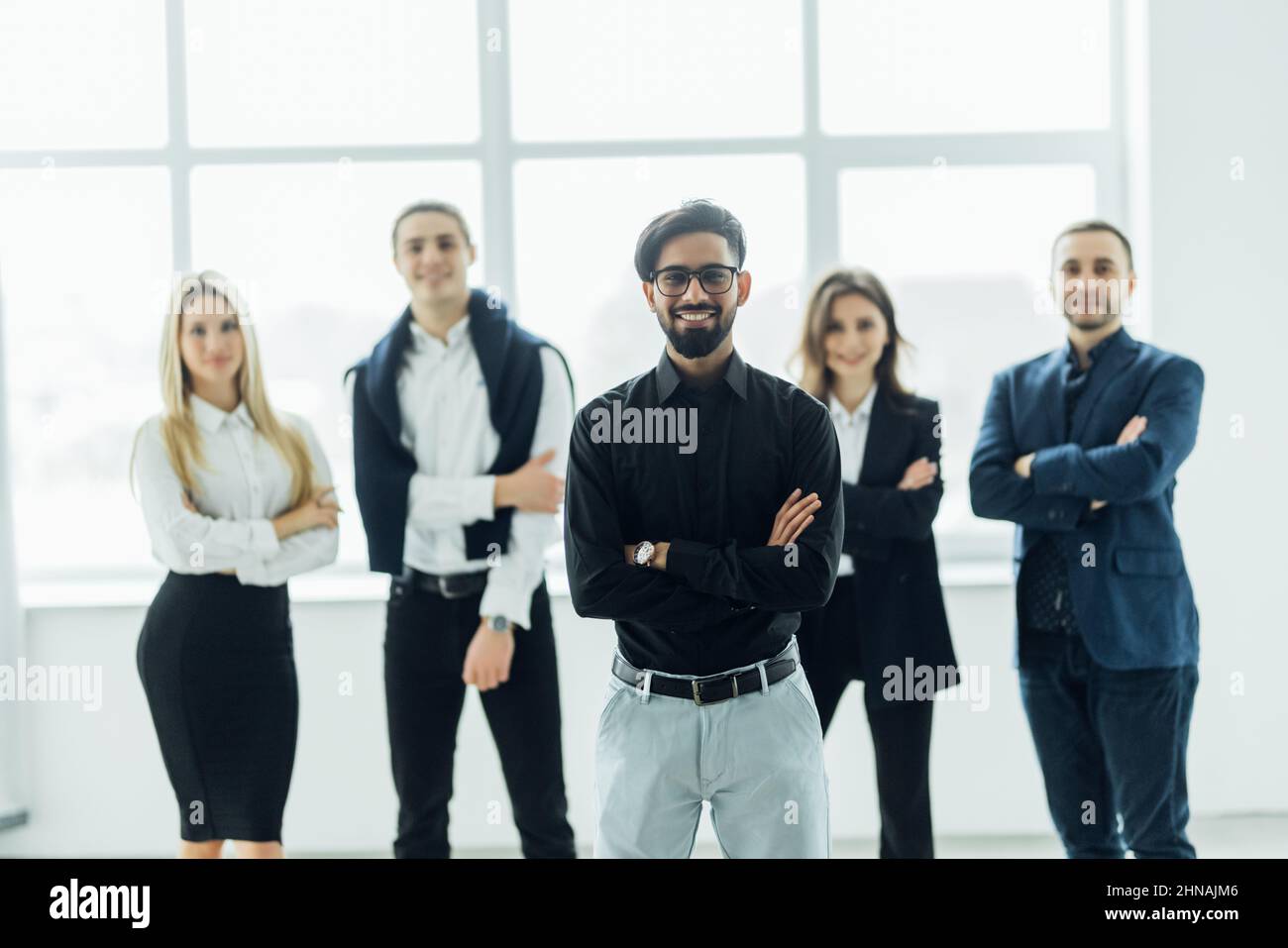 Portrait of standing in row smiling diverse team posing differently ...