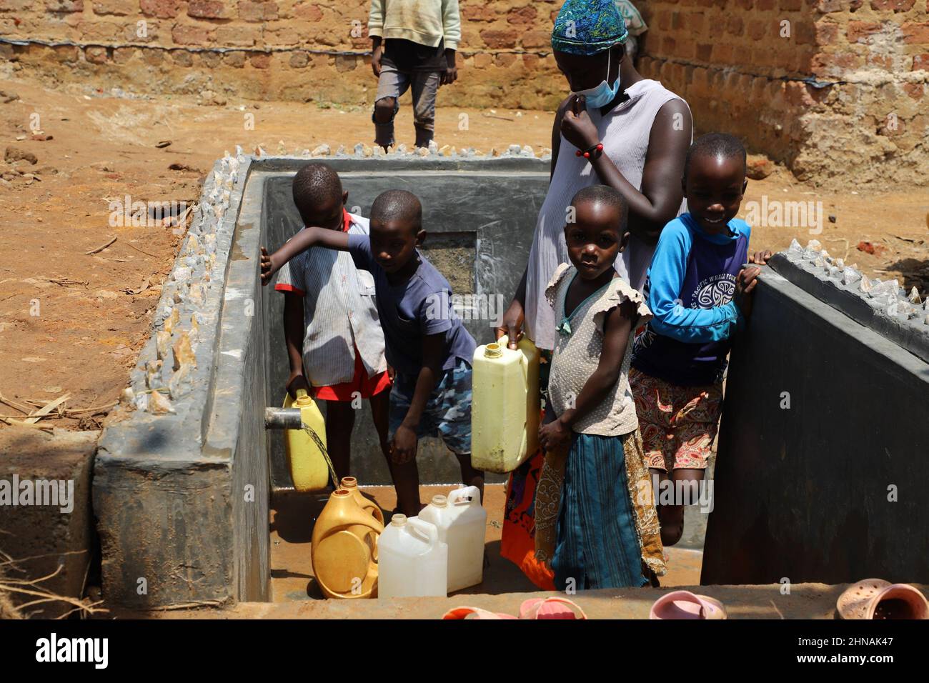 Wakiso, Uganda. 12th Feb, 2022. Villagers fetch water from a new water ...