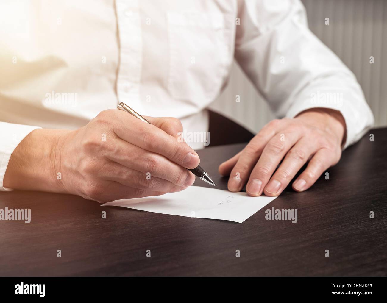 Businessman taking memo note closeup at desk and writing reminder on ...