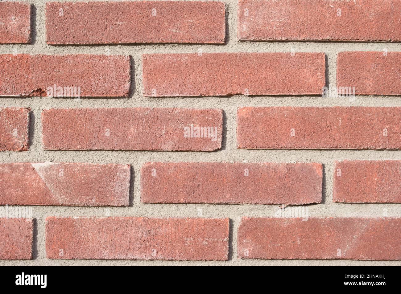 Red stone brick wall texture background Stock Photo - Alamy