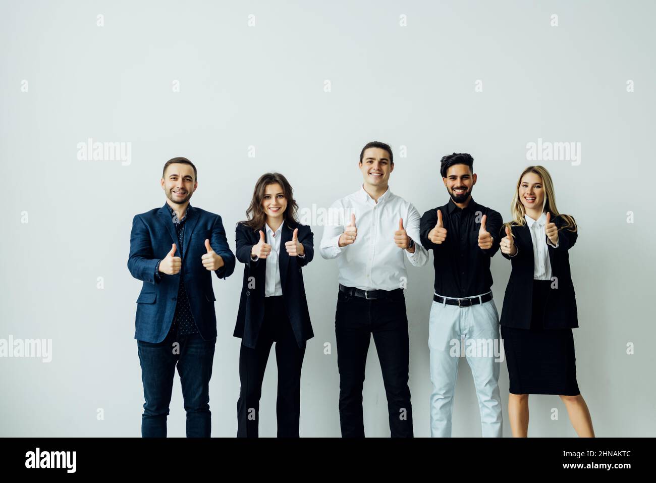 Group of six young people clients customers standing in line looking at ...