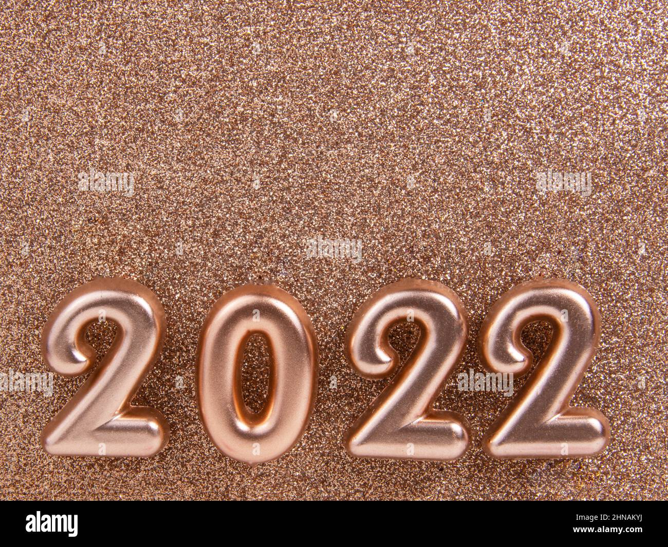 Golden decorative shiny numbers 2022 new year on gold background with ...