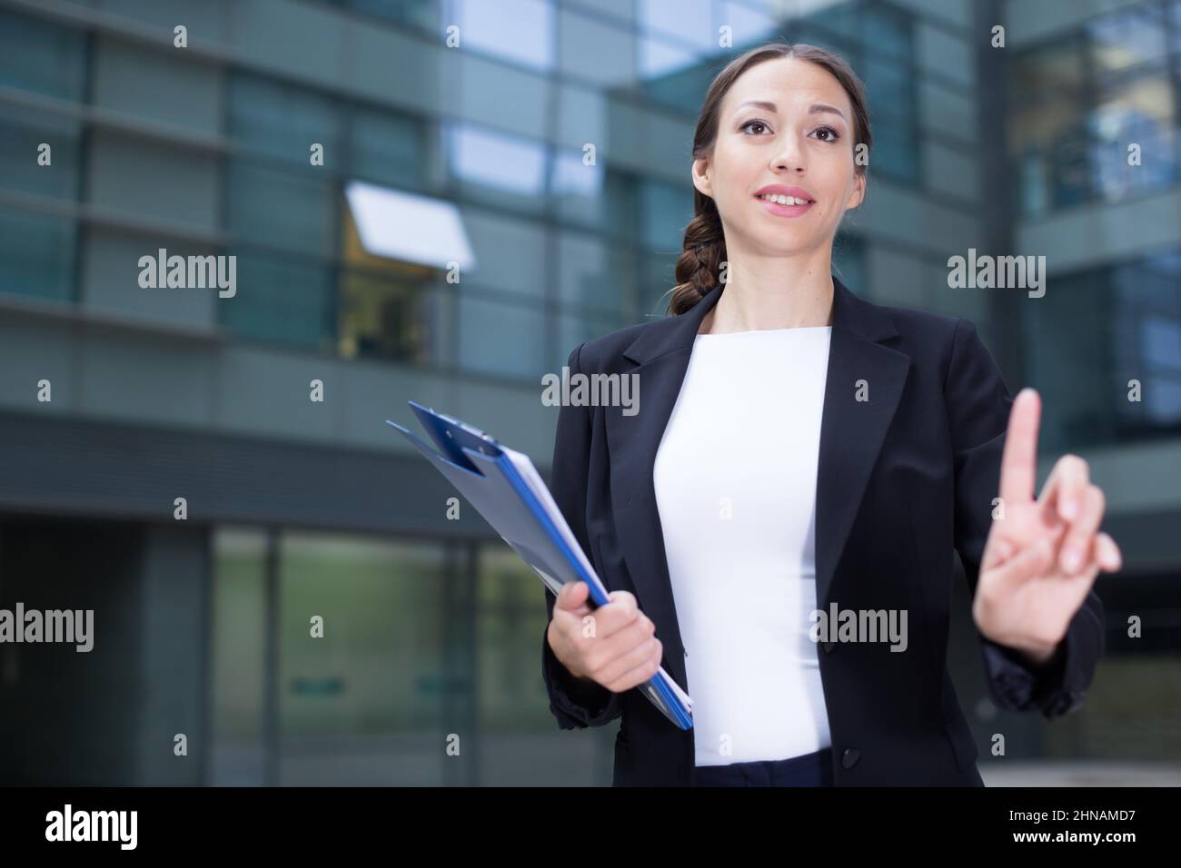 Female office manager is asking companion to wait Stock Photo - Alamy