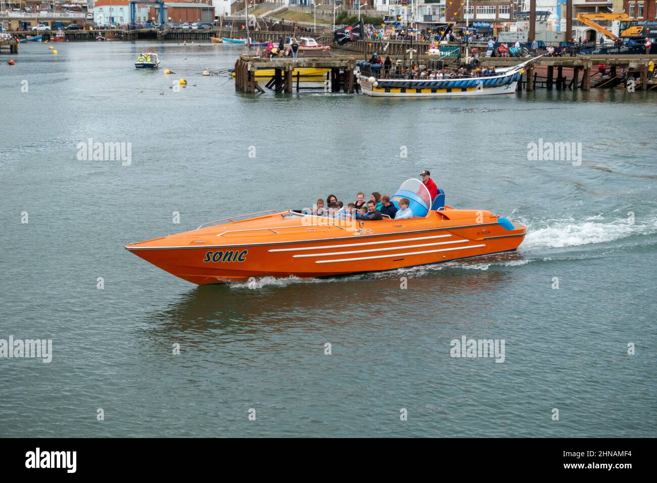 Speed boat tour boat departing from Bridlington harbour, a coastal town ...