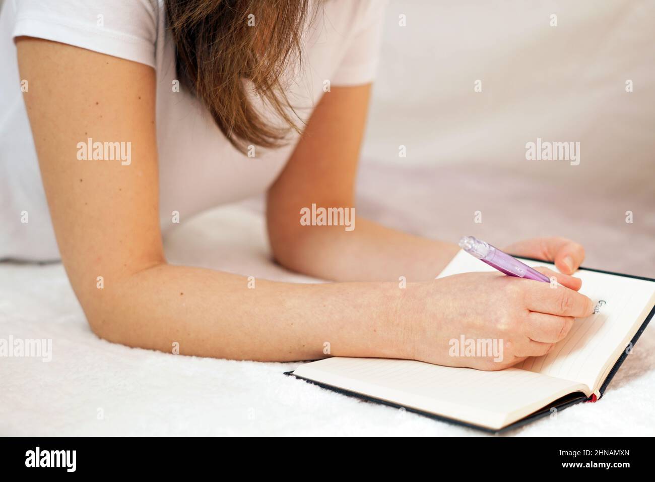 Closeup shot of a beautiful Caucasian woman laying on ground and ...