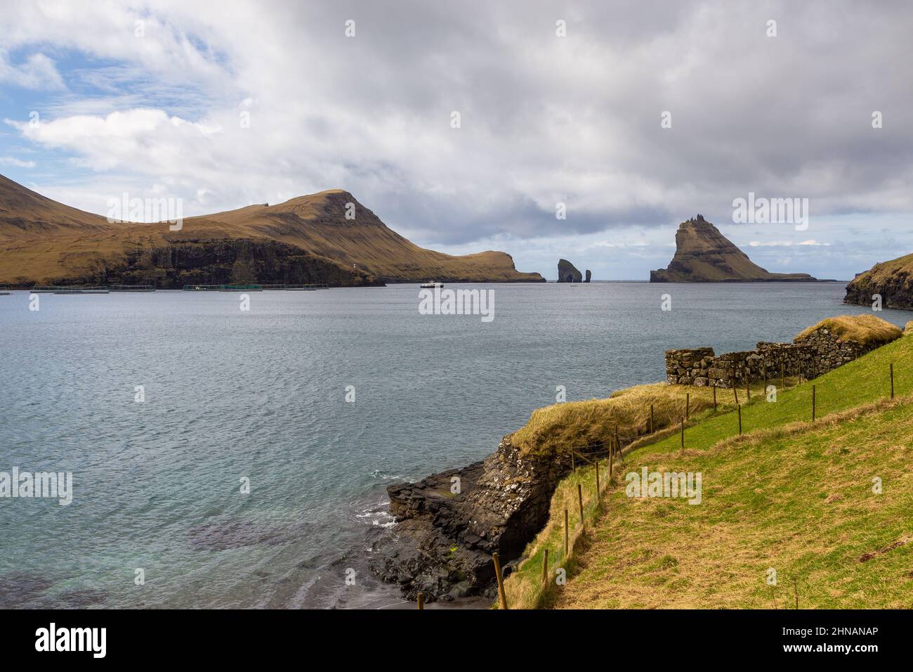 View of the coast near Bour on the island of Vagar. Massive cliffs ...