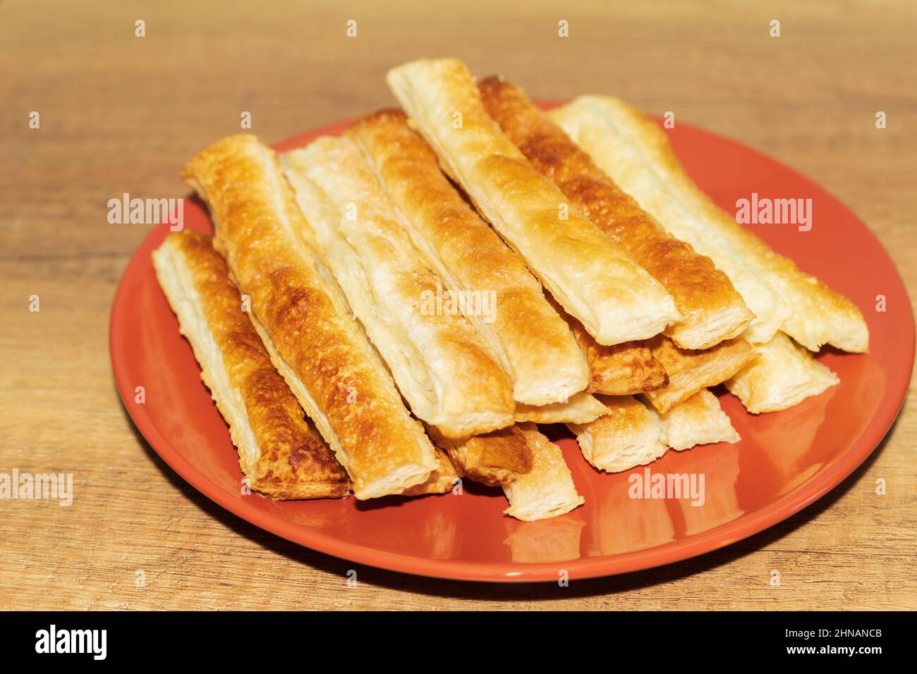 Delicious and sweet puff pastry sticks with cinnamon. Background with ...