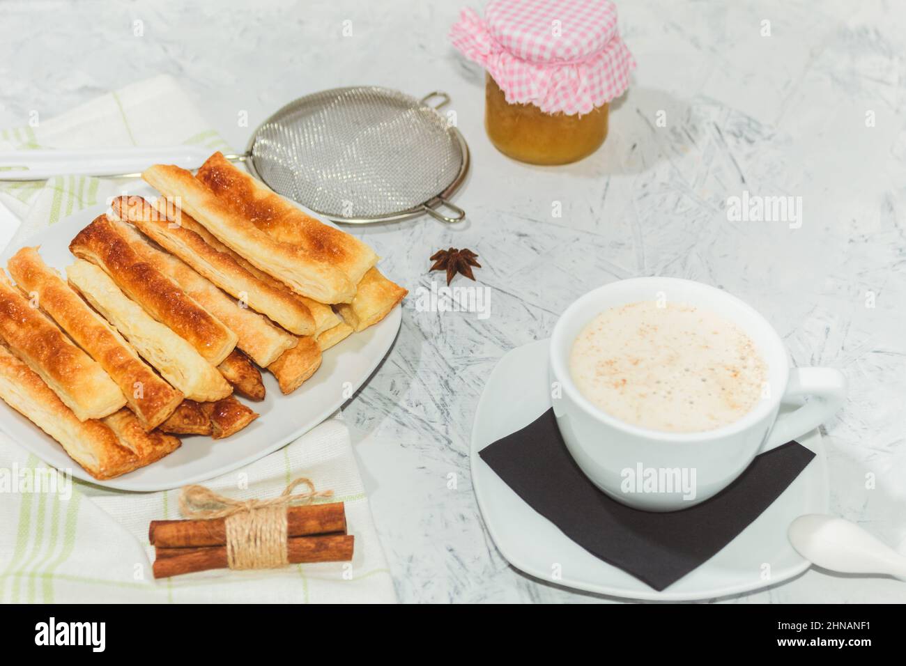 Delicious and sweet puff pastry sticks with cinnamon. Background with ...