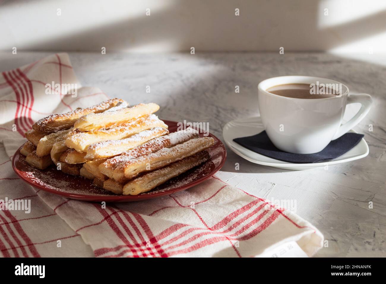 Delicious and sweet puff pastry sticks with cinnamon. Background with ...