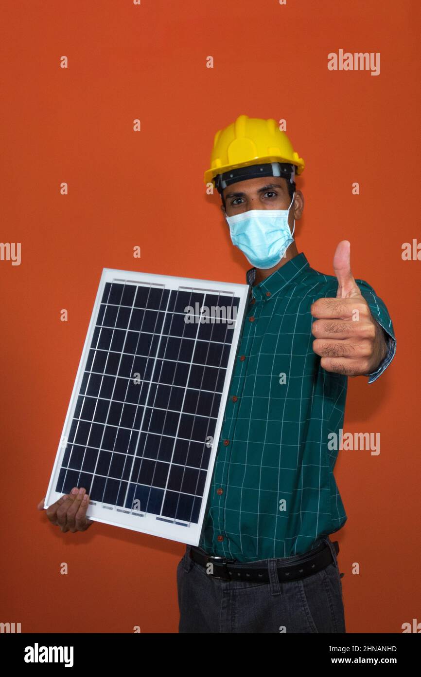 Worker With Helmet and Pandemic Mask Holding a Solar Photovoltaic Panel ...