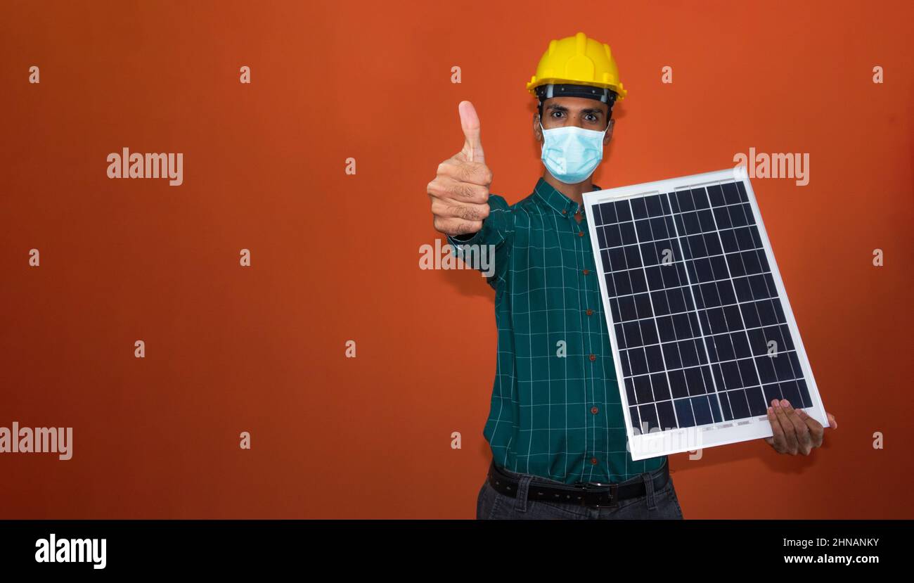 Worker With Helmet and Pandemic Mask Holding a Solar Photovoltaic Panel ...