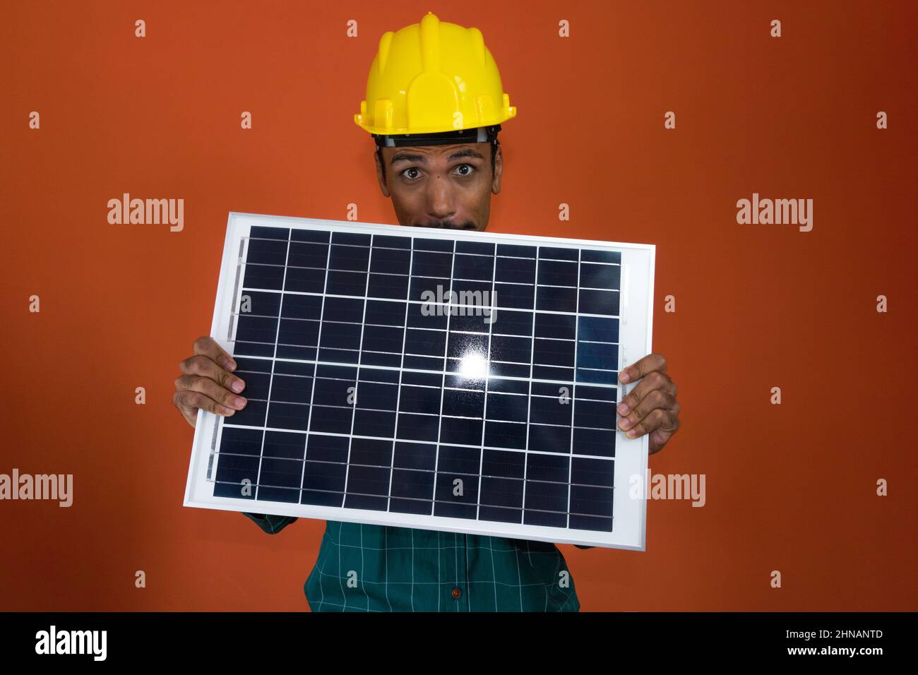 Worker With Helmet Holding a Solar Photovoltaic Panel isolated. Solar ...