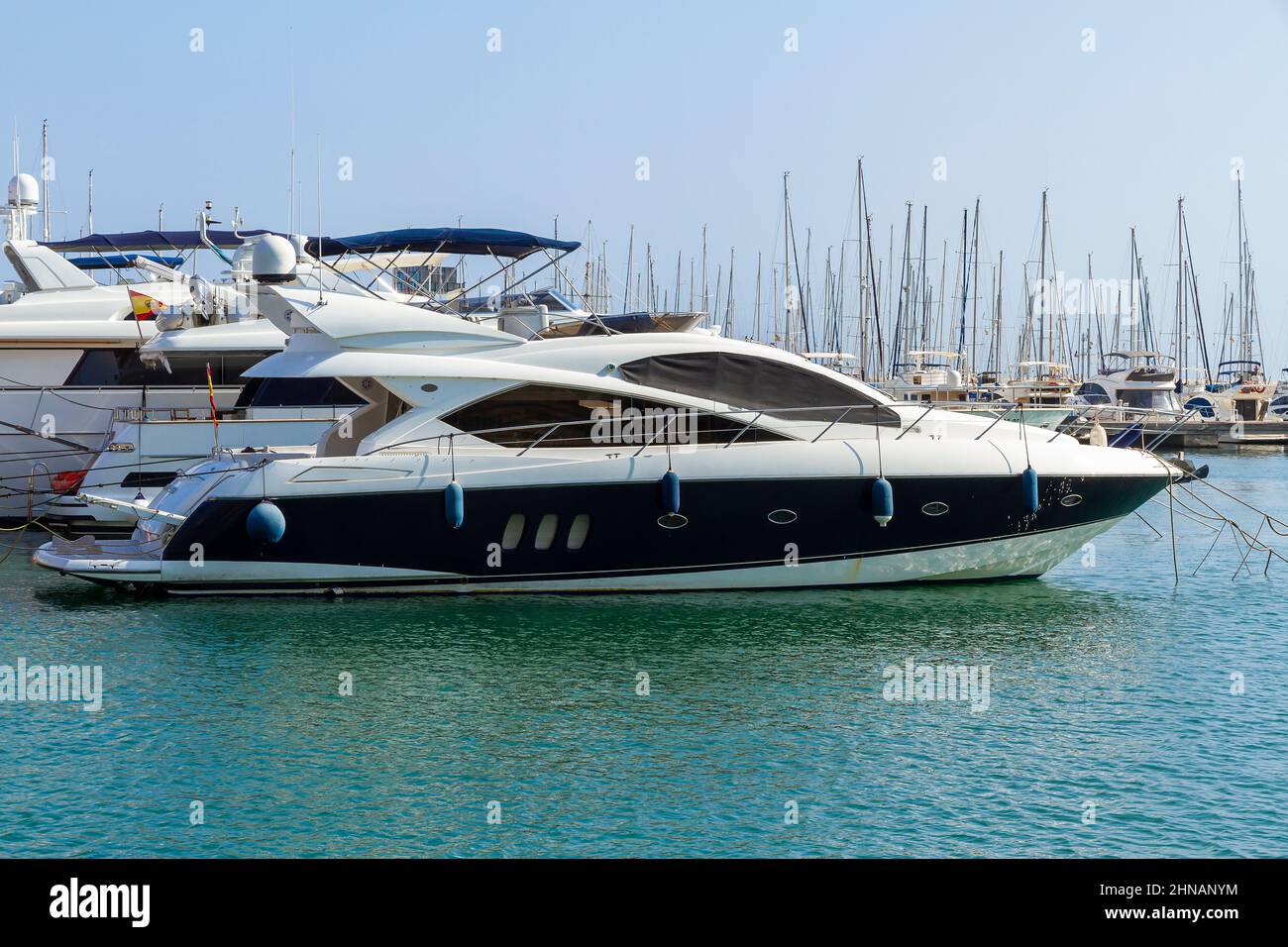 horizontal view of a yacht in the foreground docked in the marina Stock ...