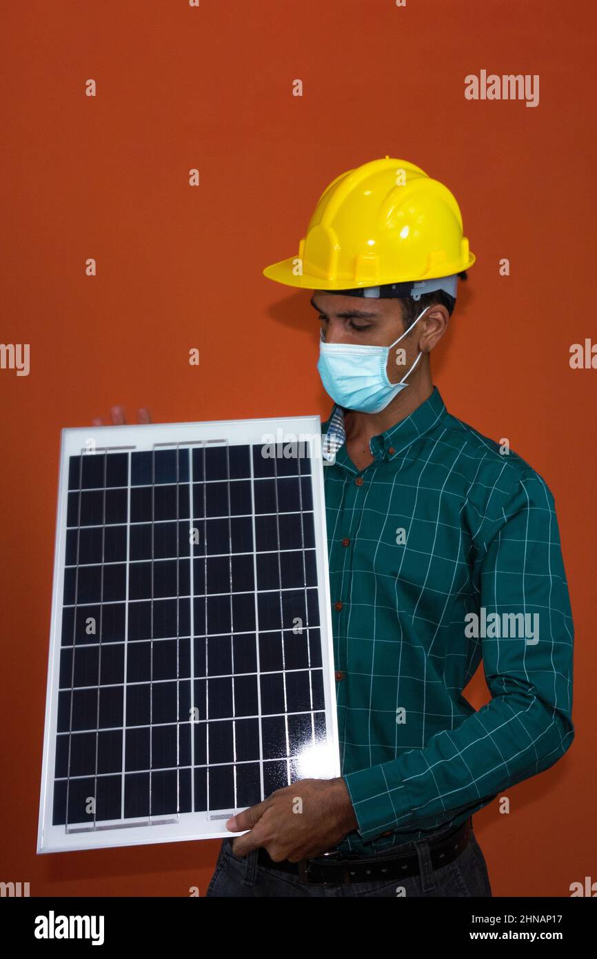 Worker With Helmet and Pandemic Mask Holding a Solar Photovoltaic Panel ...