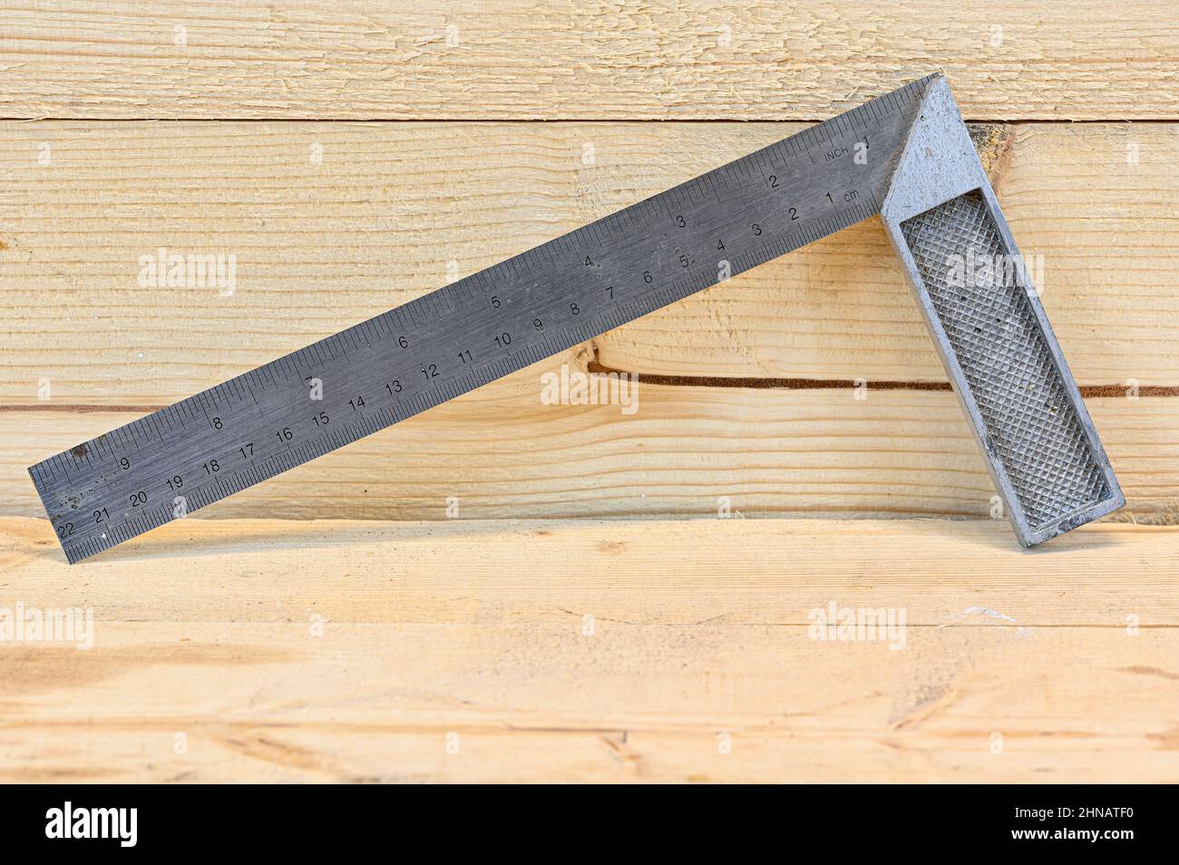 L square of metal standing on wooden bench Stock Photo - Alamy
