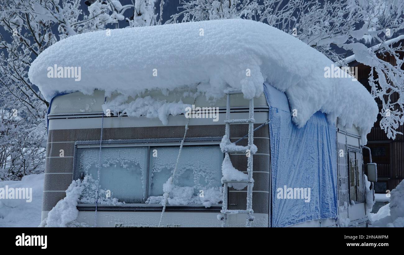Trailer house covered in snow at a mountainous landscape Stock Photo ...