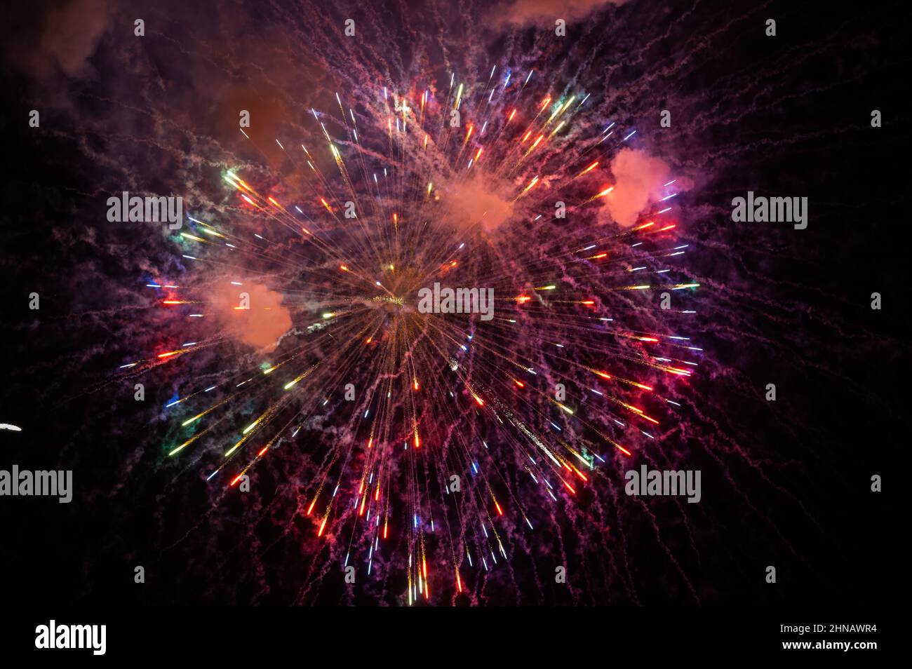 Scenic view of lots of vivid fireworks glowing in a dark sky Stock ...