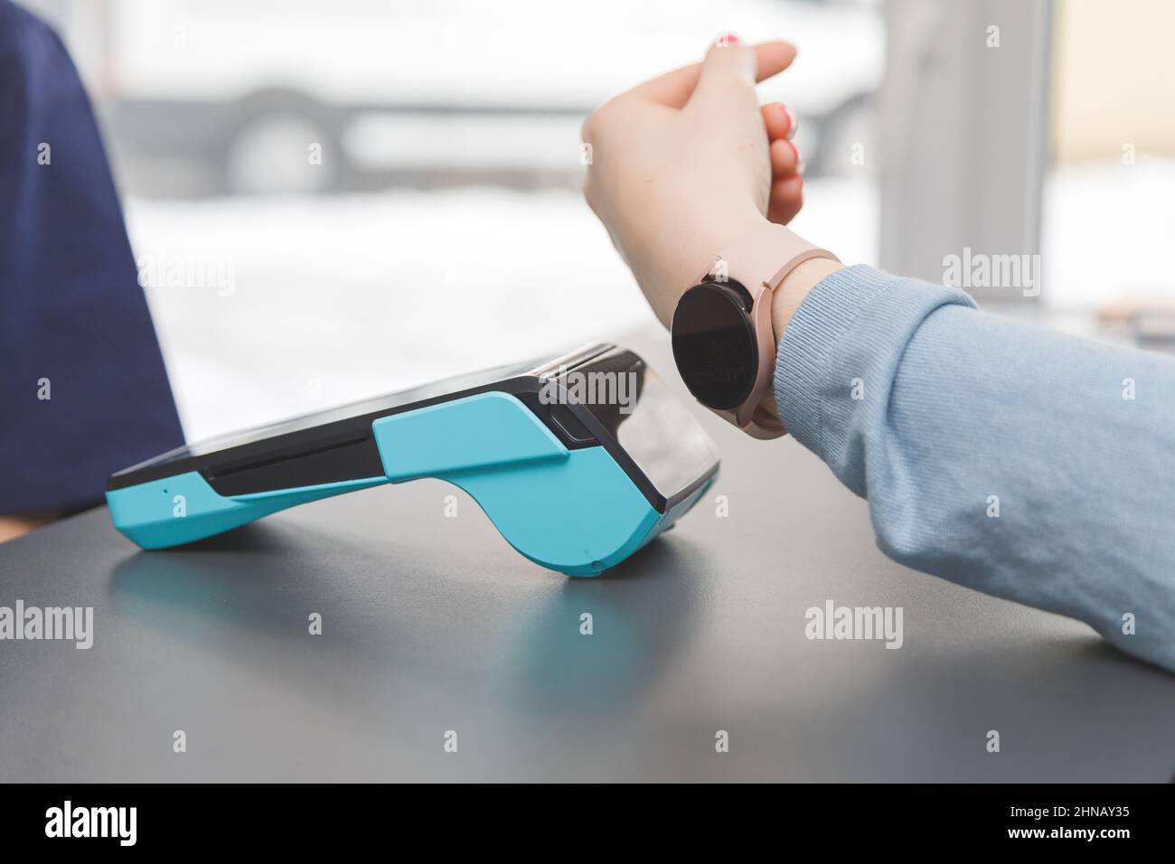 Customer making wireless or contactless payment using smartwatch. Store ...