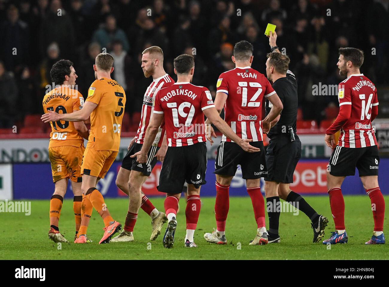 Referee Oliver Langford gives a yellow card to George Honeyman #10 of ...