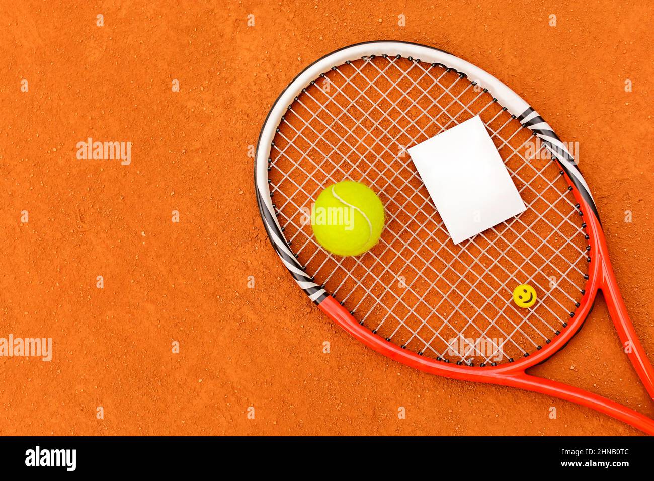 Tennis balls and racket on tennis court Stock Photo - Alamy