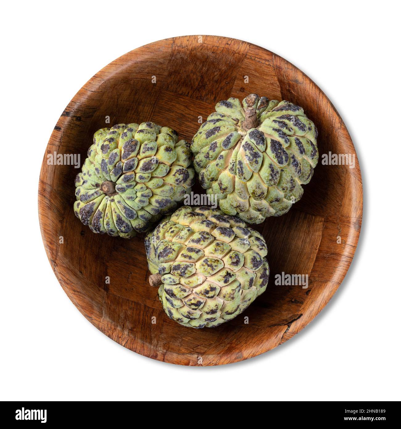 Sugar apples or custard apples in a bowl isolated over white background ...