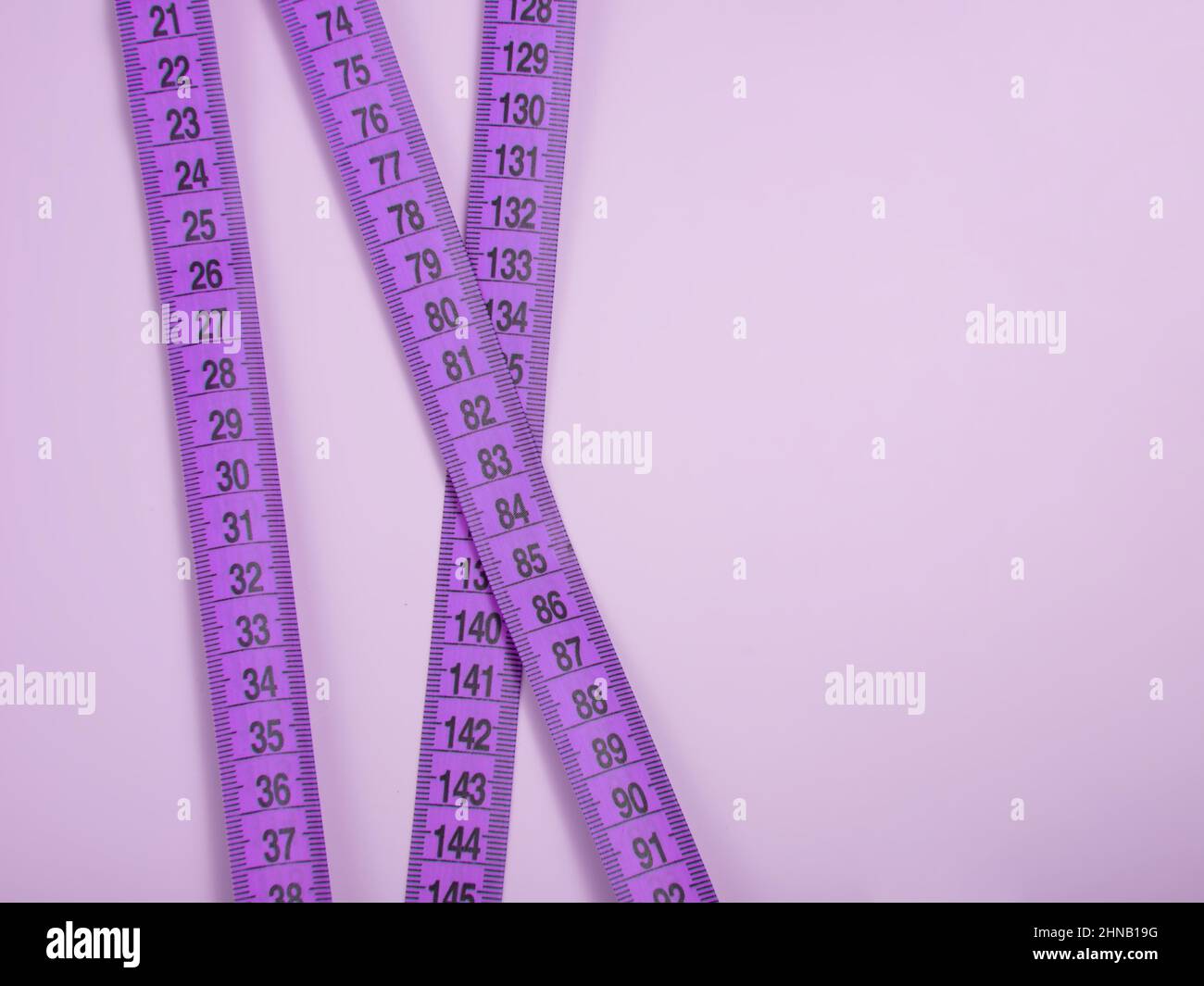 Bright purple tape measure on violet background with copyspace Stock ...