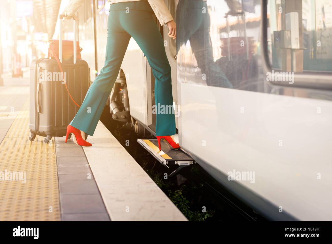 Legs's close up of a business woman getting on the train with bag and ...