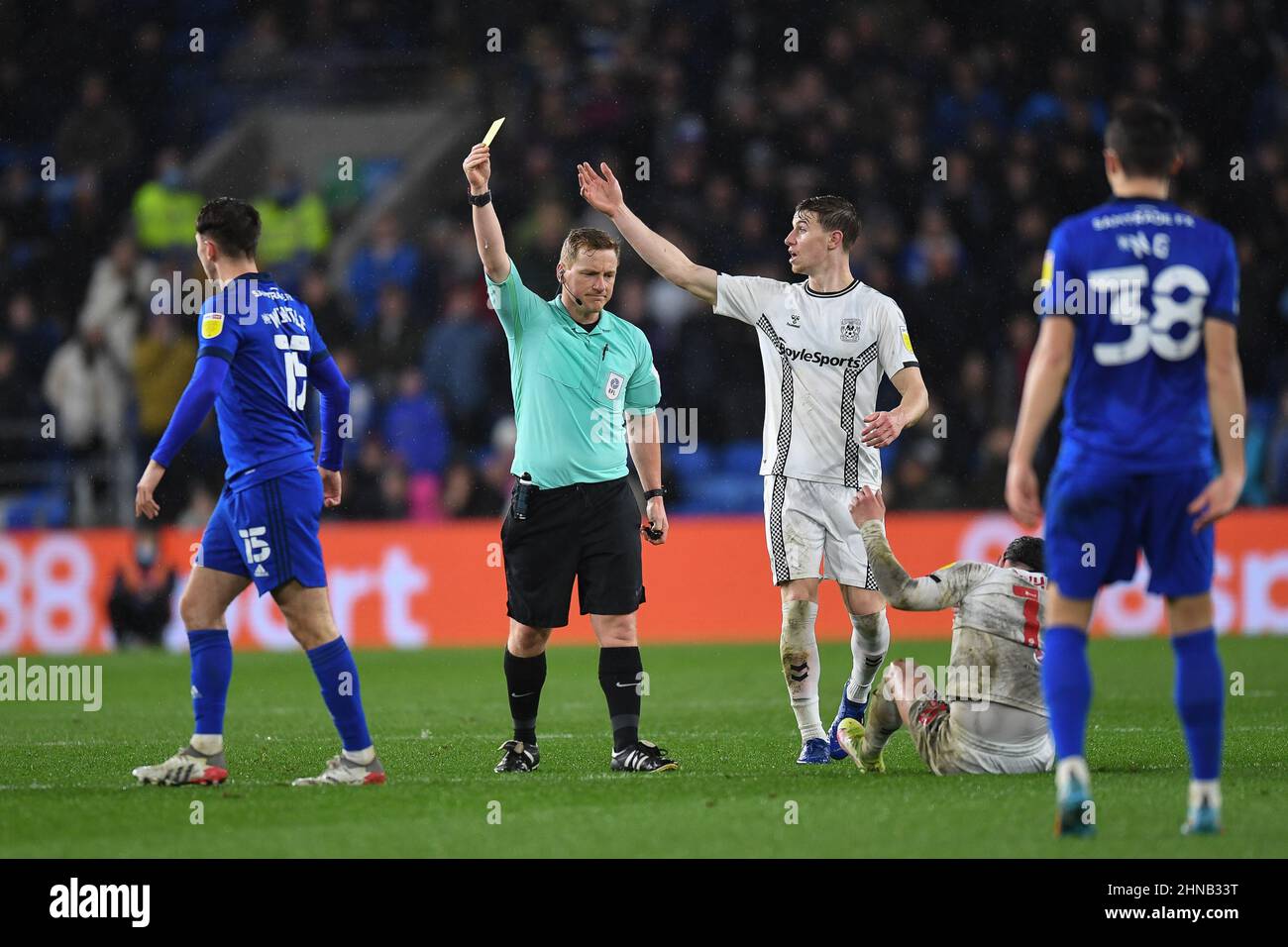 Ryan Wintle #15 of Cardiff City receives a yellow card from John Busby ...