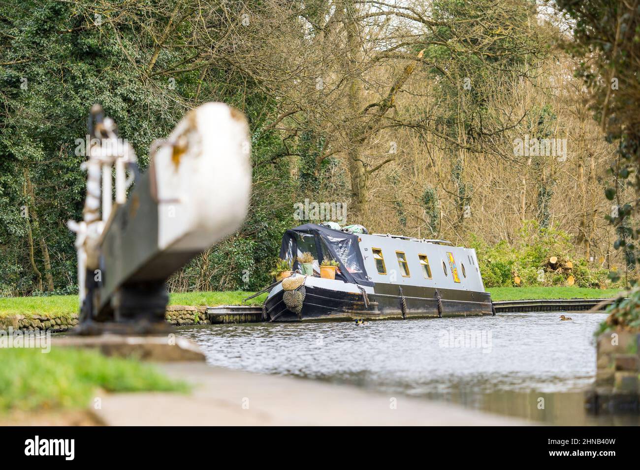 View of a moored narrowboat/ canal boat on UK canal water looking from ...