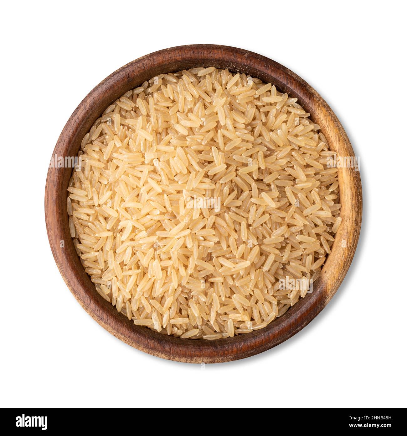 Raw brown whole rice in a bowl isolated over white background Stock ...
