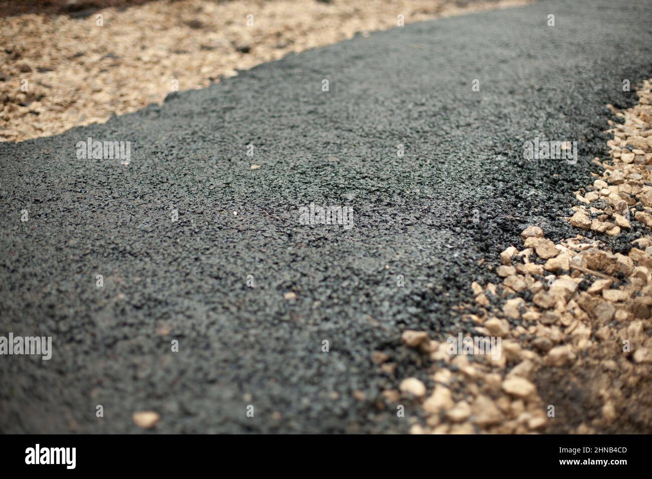 New asphalt. Construction of path in park. Details of road surface ...