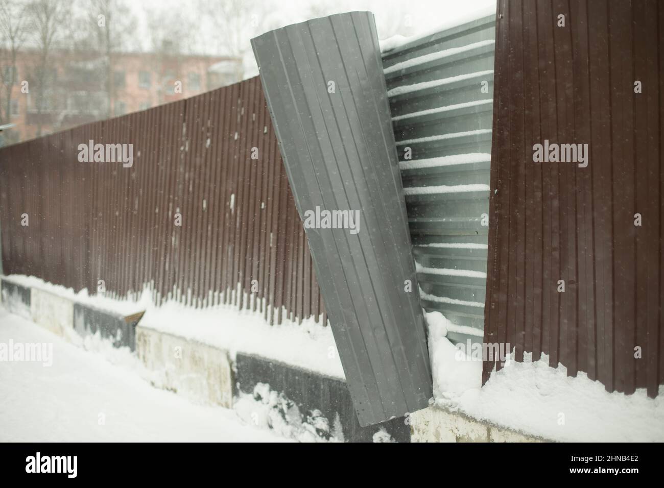 Broken fence. Steel fence buckled away from gusts of wind. Territory is ...