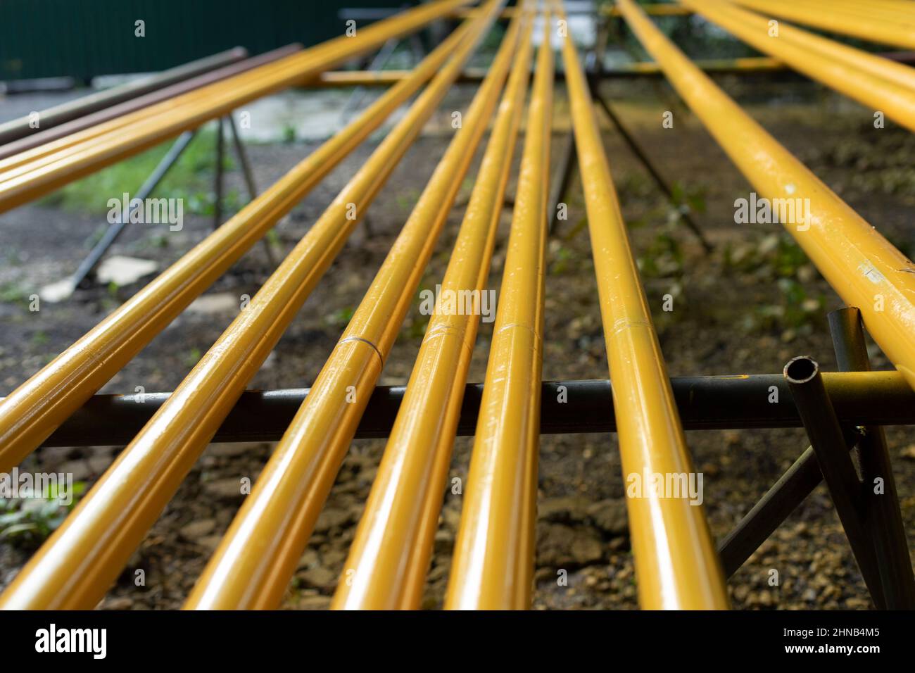 Yellow pipes. Gas pipes lie in row. Preparation of equipment ...