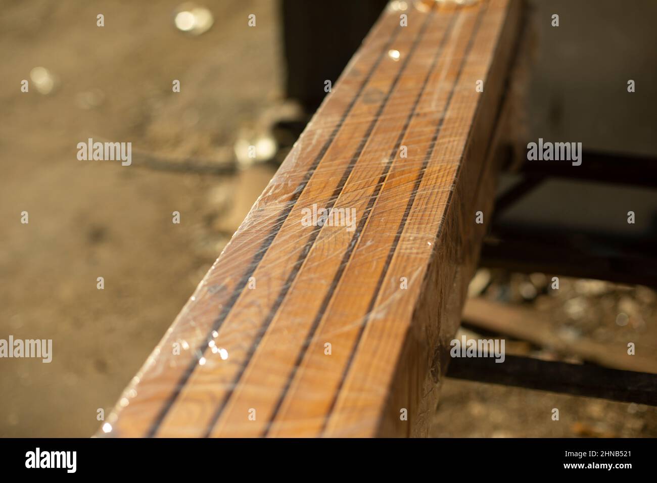 Film-wrapped board. Details of workshop. Stretch film for wood ...