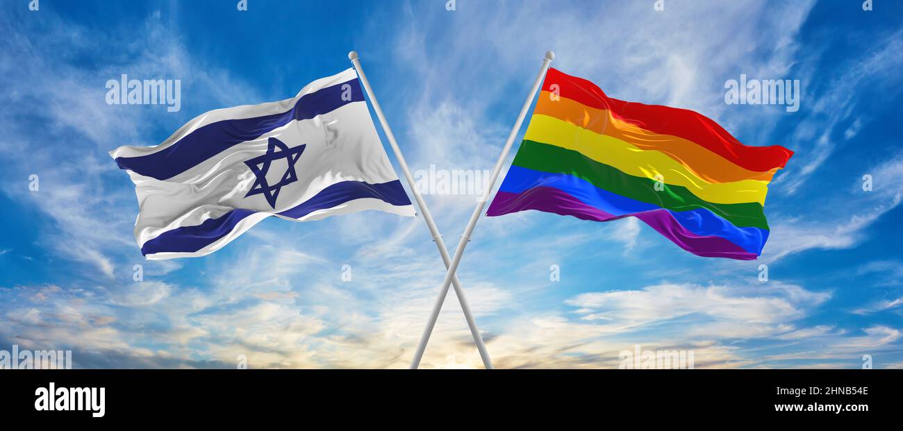 crossed national flags of Israel and LGBT Pride flag waving in the wind ...