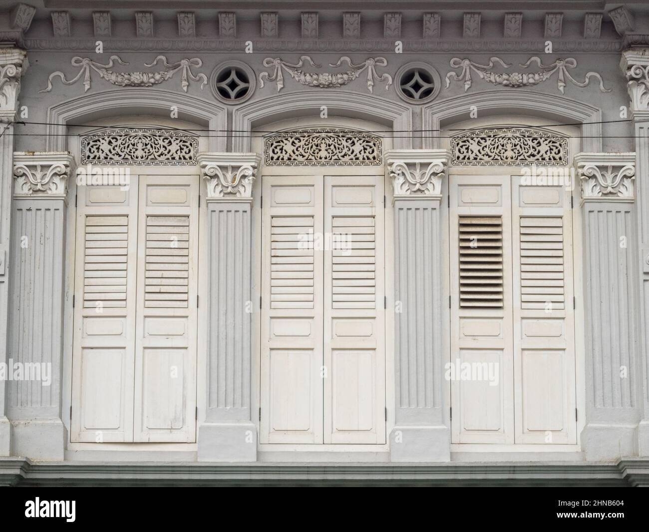 Traditional white shutters of a shophouse in Little India - Singapore ...