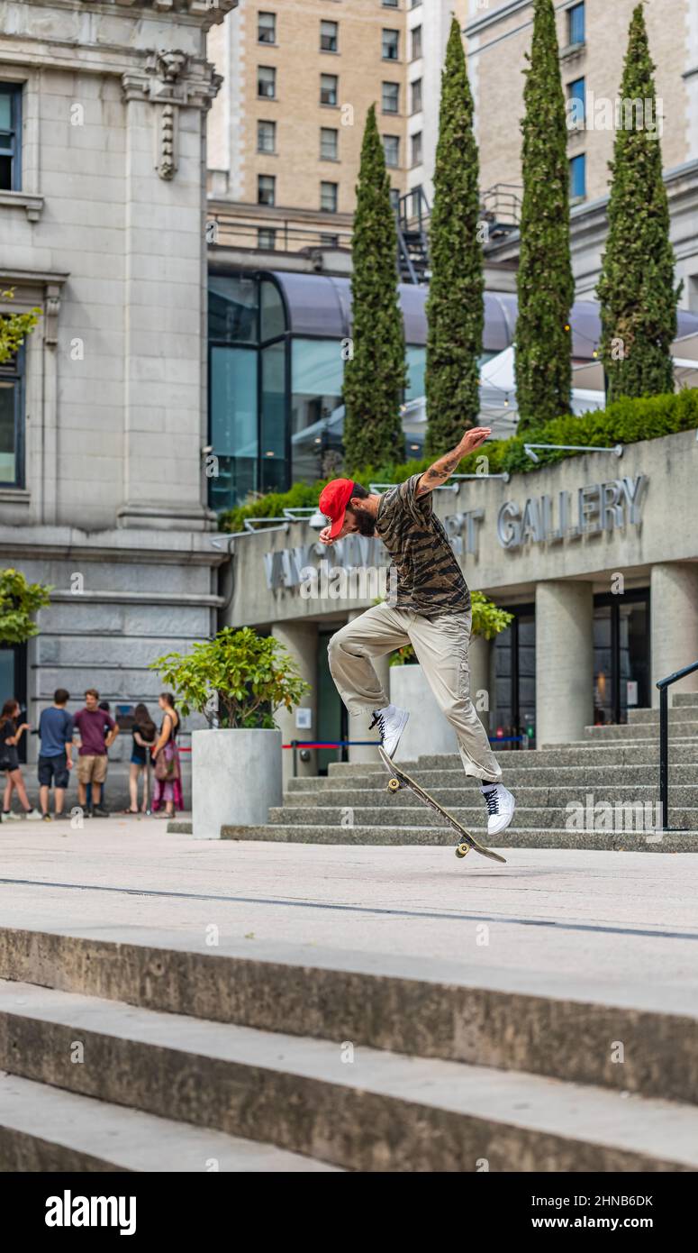 Skateboarder doing a skateboard jumping trick from stairs Stock Photo ...