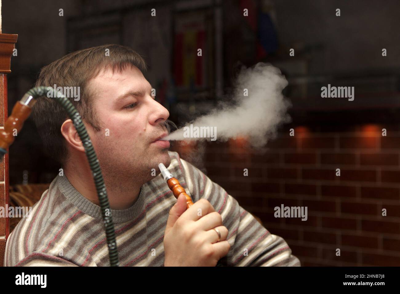 The man resting with hookah at shisha house Stock Photo - Alamy