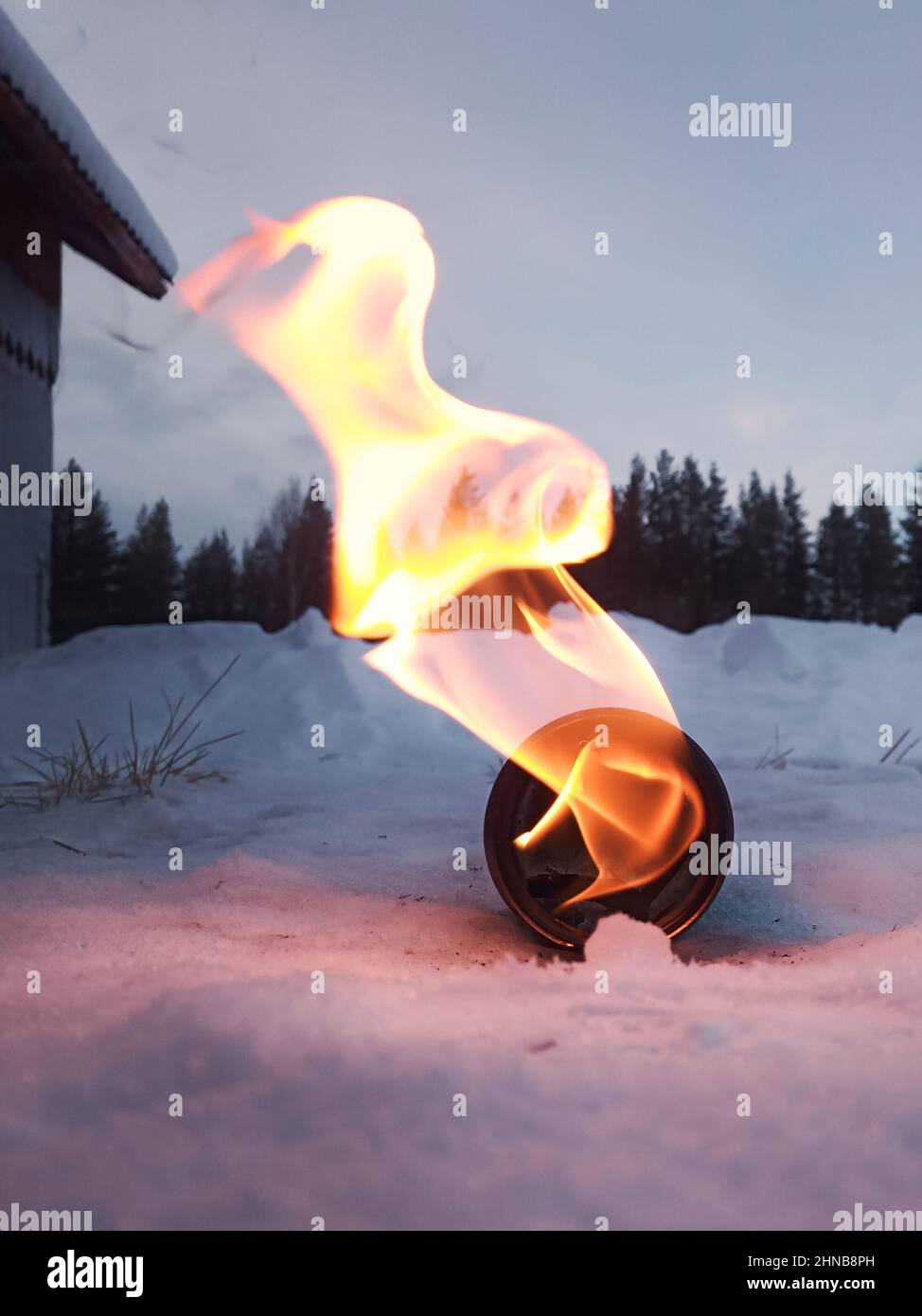 Burning glass, lying in snow and ice Stock Photo - Alamy