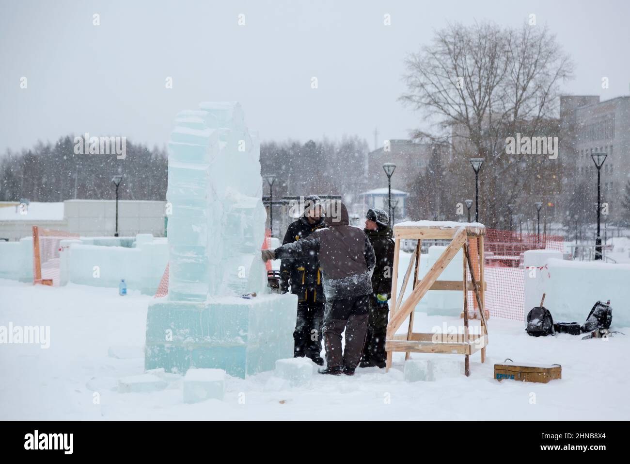 Installers at the ice figure at the construction site are having a ...