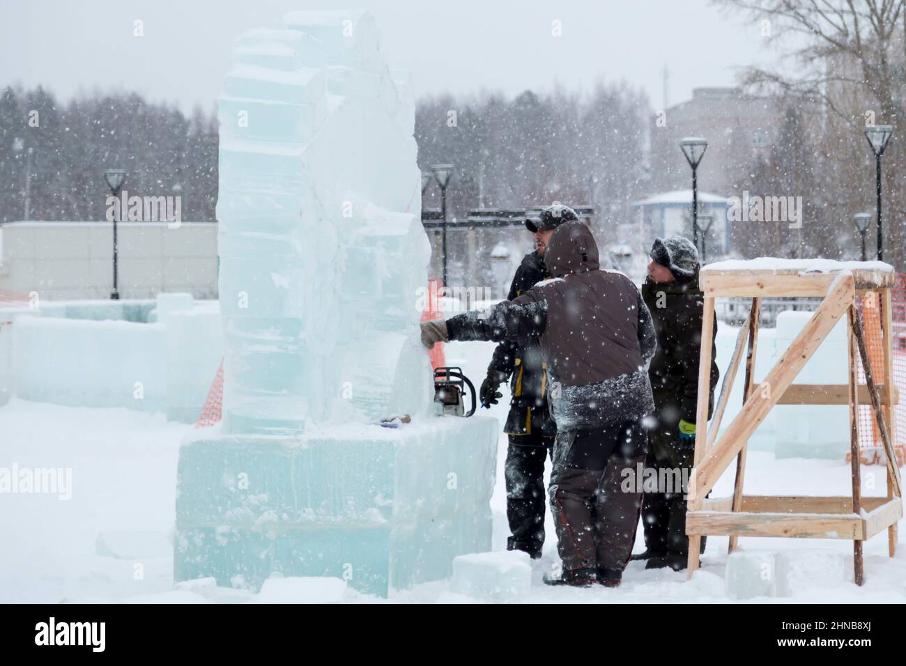Installers at the ice figure at the construction site are having a ...