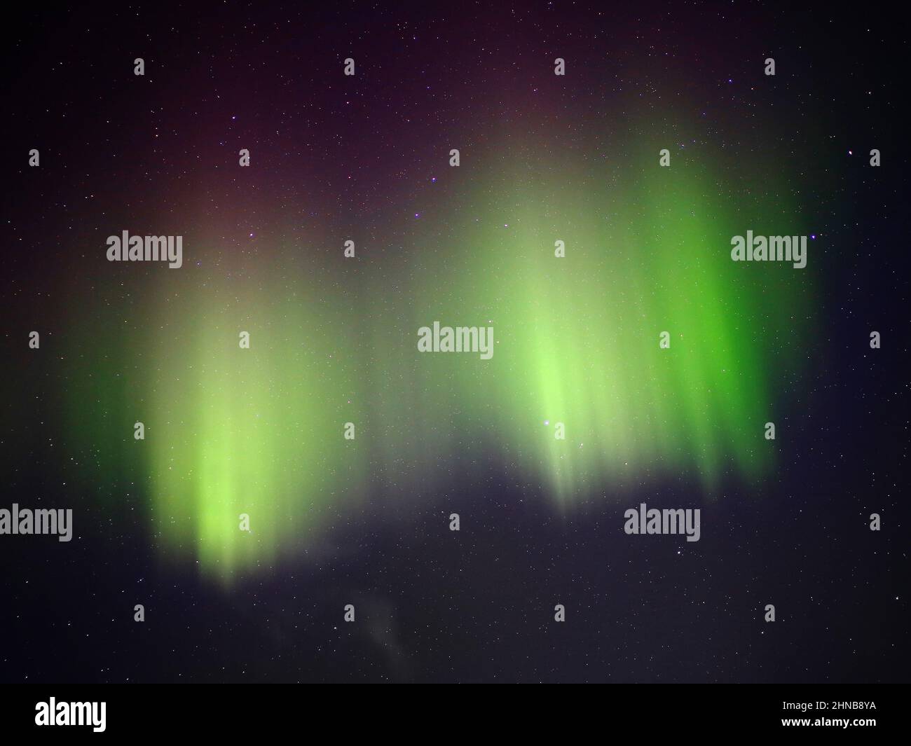 Green and red aurora borealis on night sky Stock Photo - Alamy