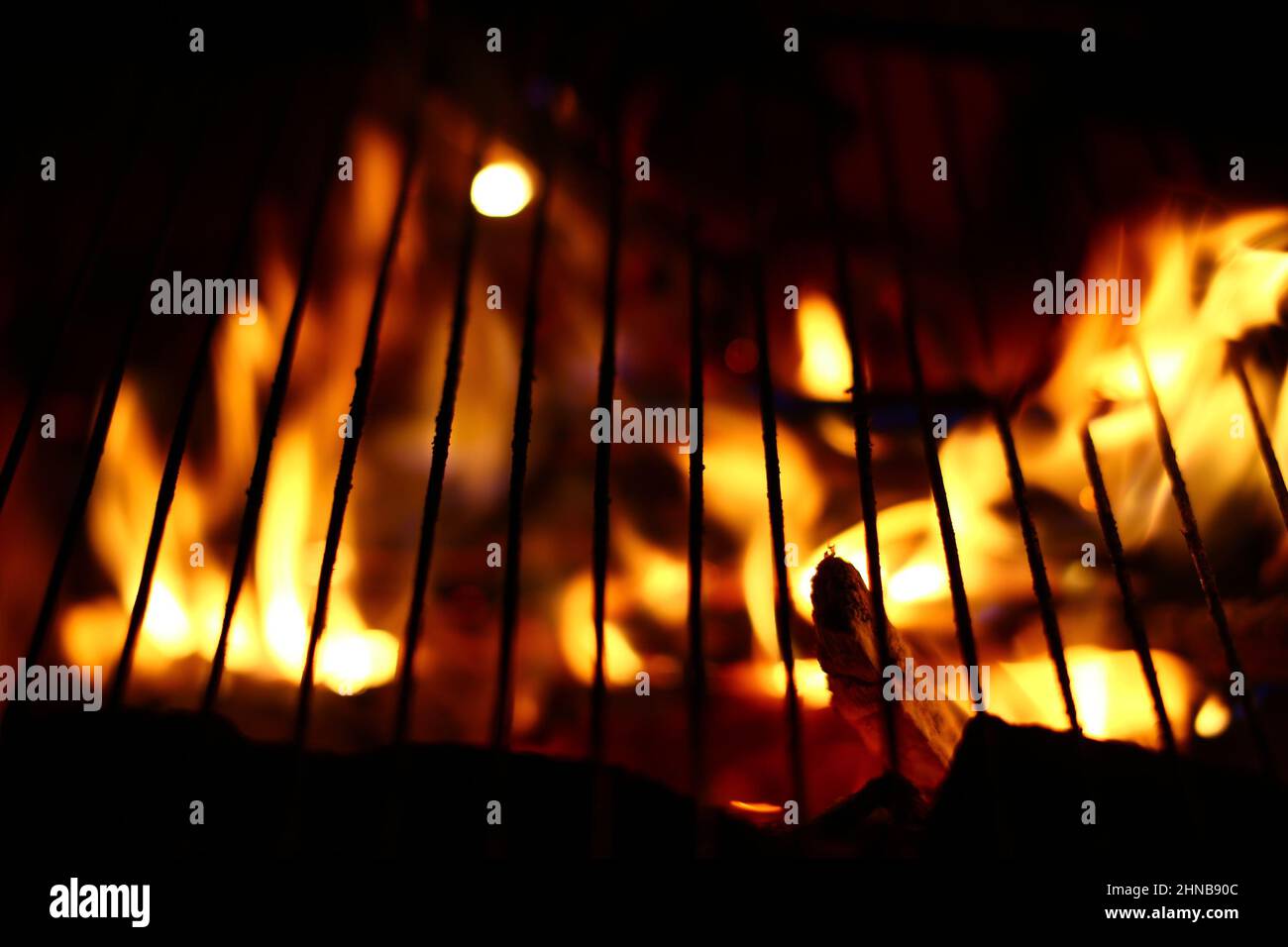Macro of a barbecue grill on fire Stock Photo - Alamy